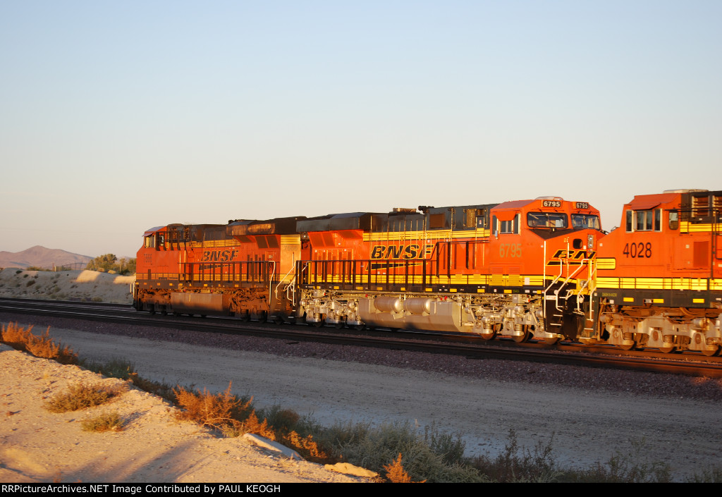 BNSF 6795 with the sun glissening off her Swoosh Logo pulls a Hot Z towards LA.